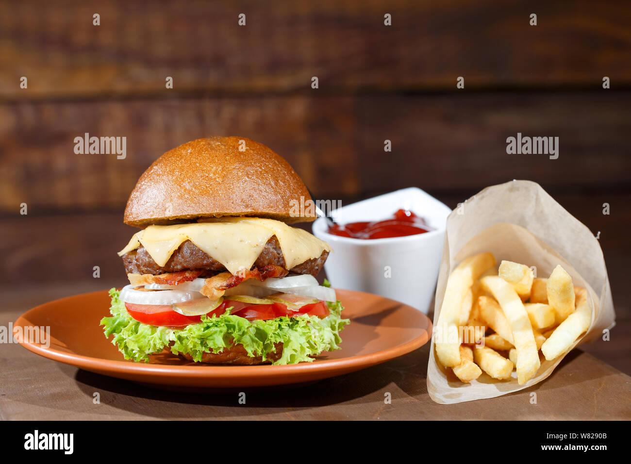 burger and french fries on the wooden table Stock Photo - Alamy