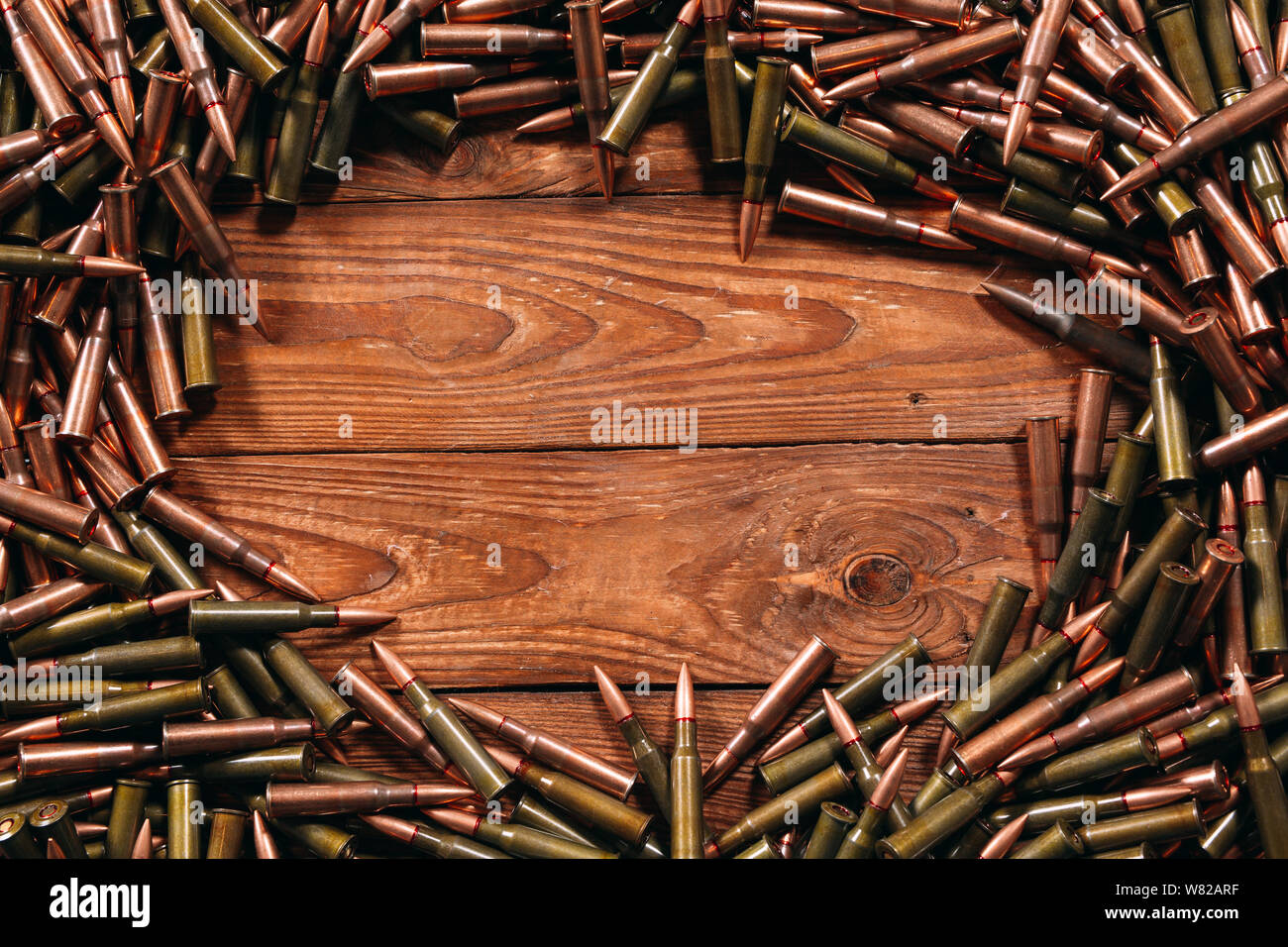 Different ammo on wooden background, weapon concept Stock Photo - Alamy