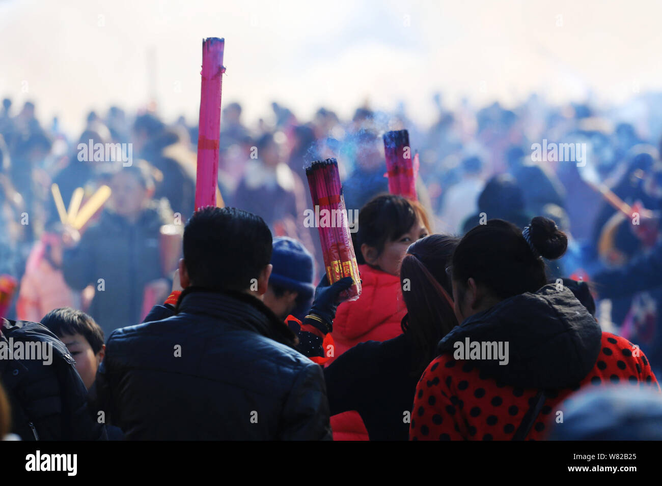 Chinese worshippers burn incense sticks to pray for good luck on the ...