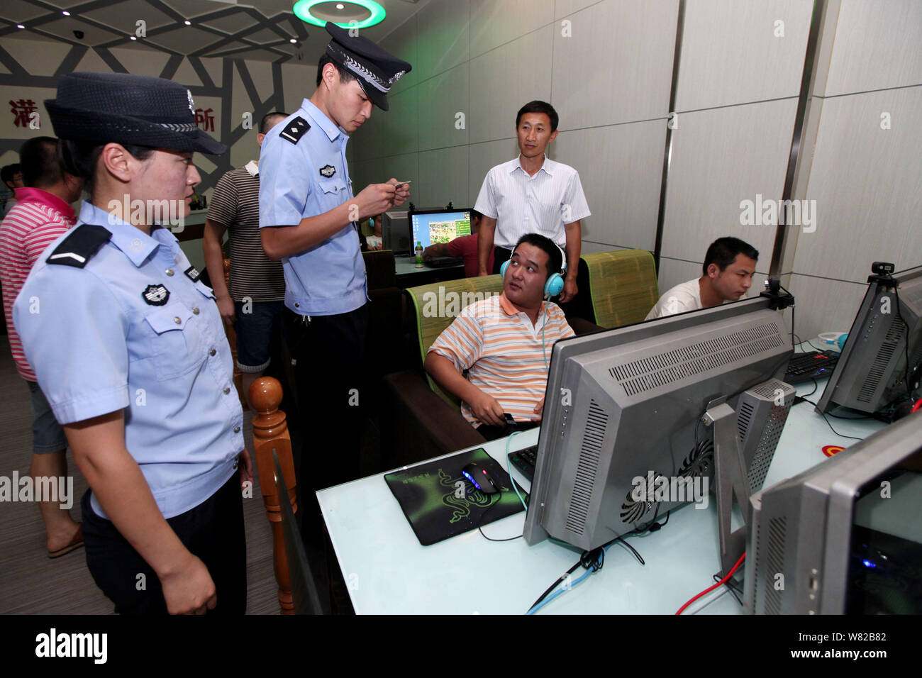 --FILE--Chinese police and law enforcement officers check ID cards of ...