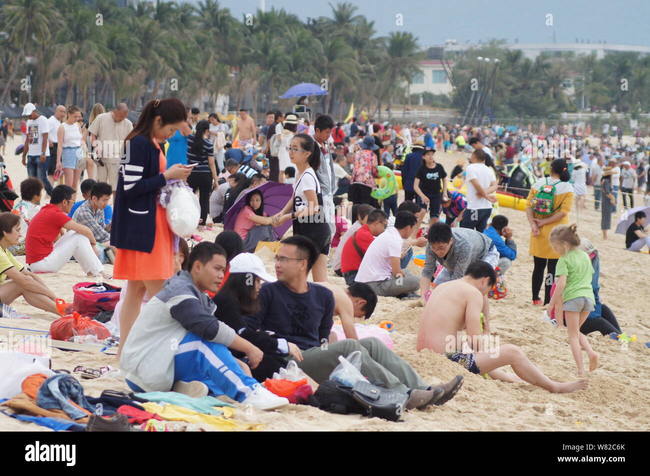 Tourists crowd a beach resort to celebrate the Chinese Lunar New Year ...