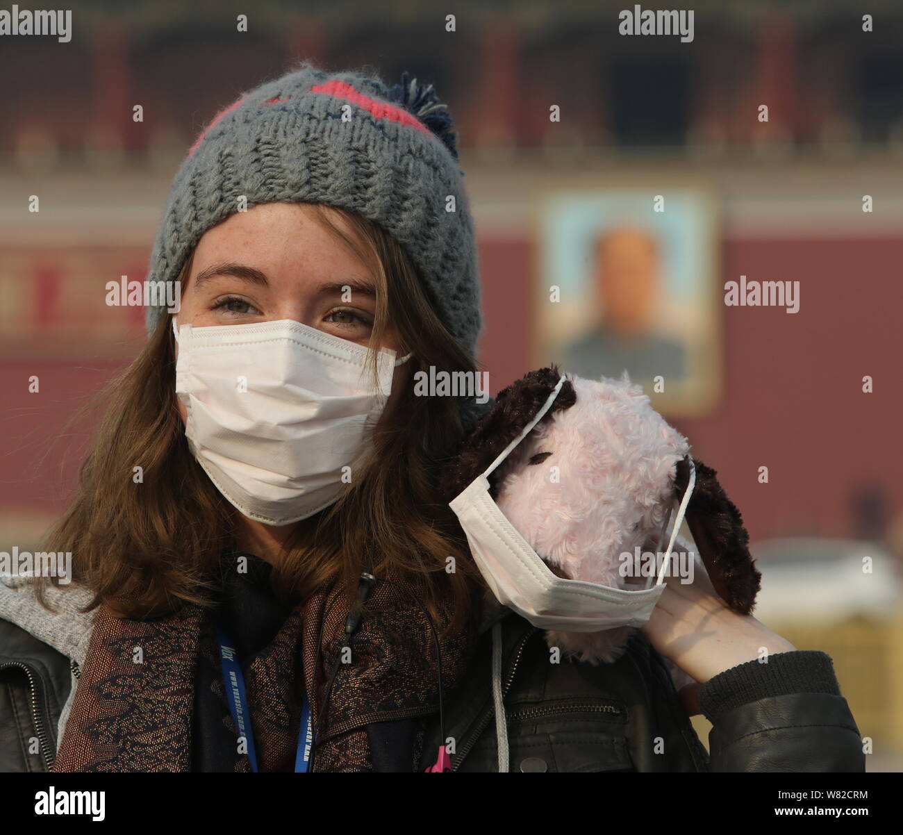 A foreign tourist wearing a face mask against air pollution visits ...