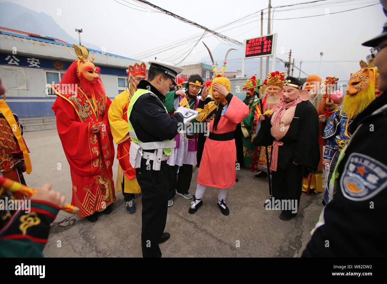 Police officers are surrounded by actors who were on their way to a ...