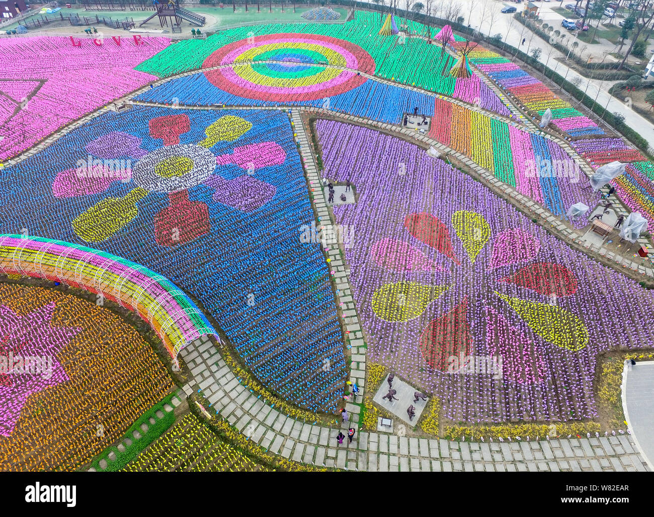 Aerial view of colorful patterns made of pinwheels in a farm field in ...