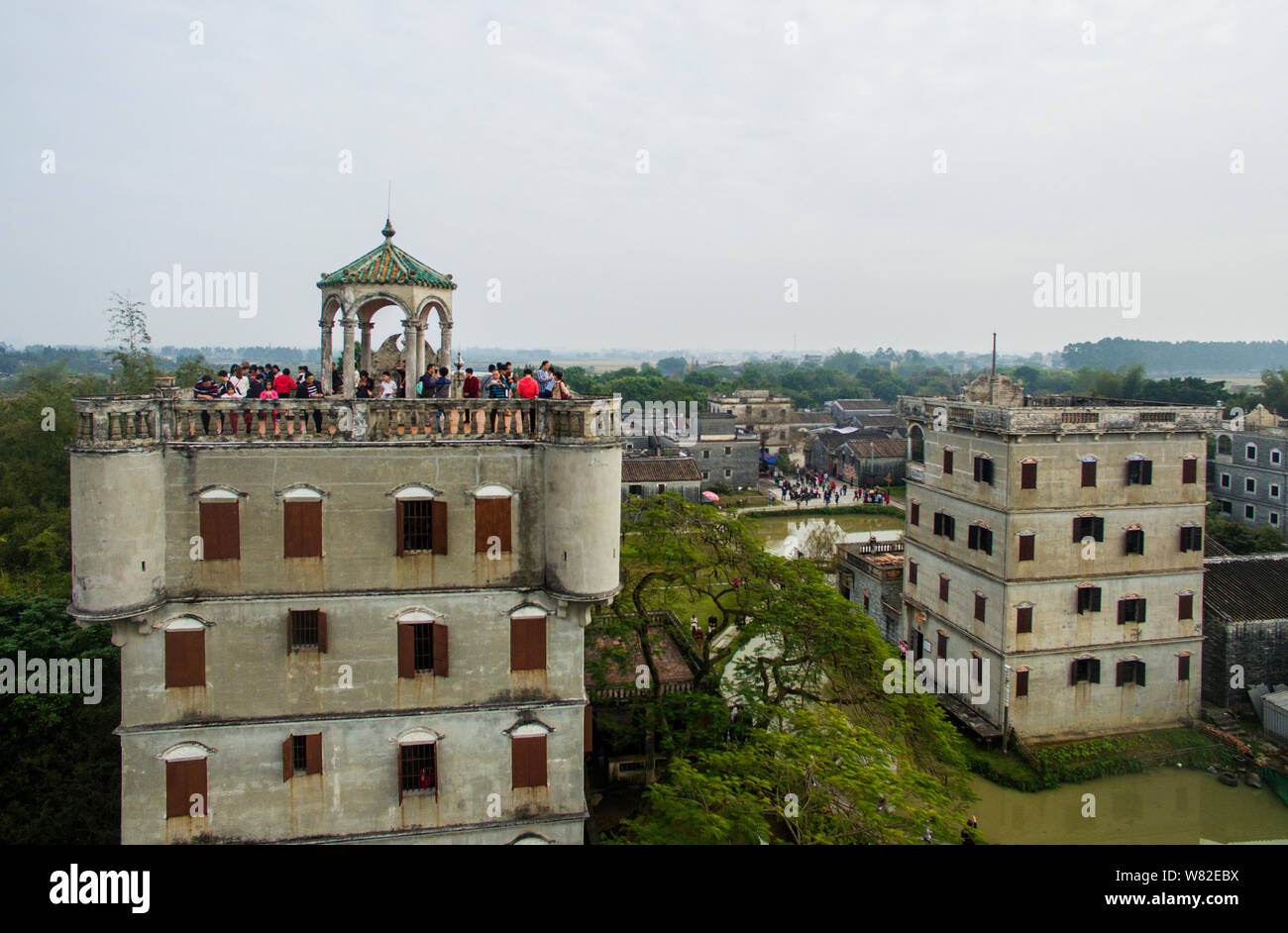 Tourists visit Kaiping Diaolou watchtowers used to stock hay in Zili ...