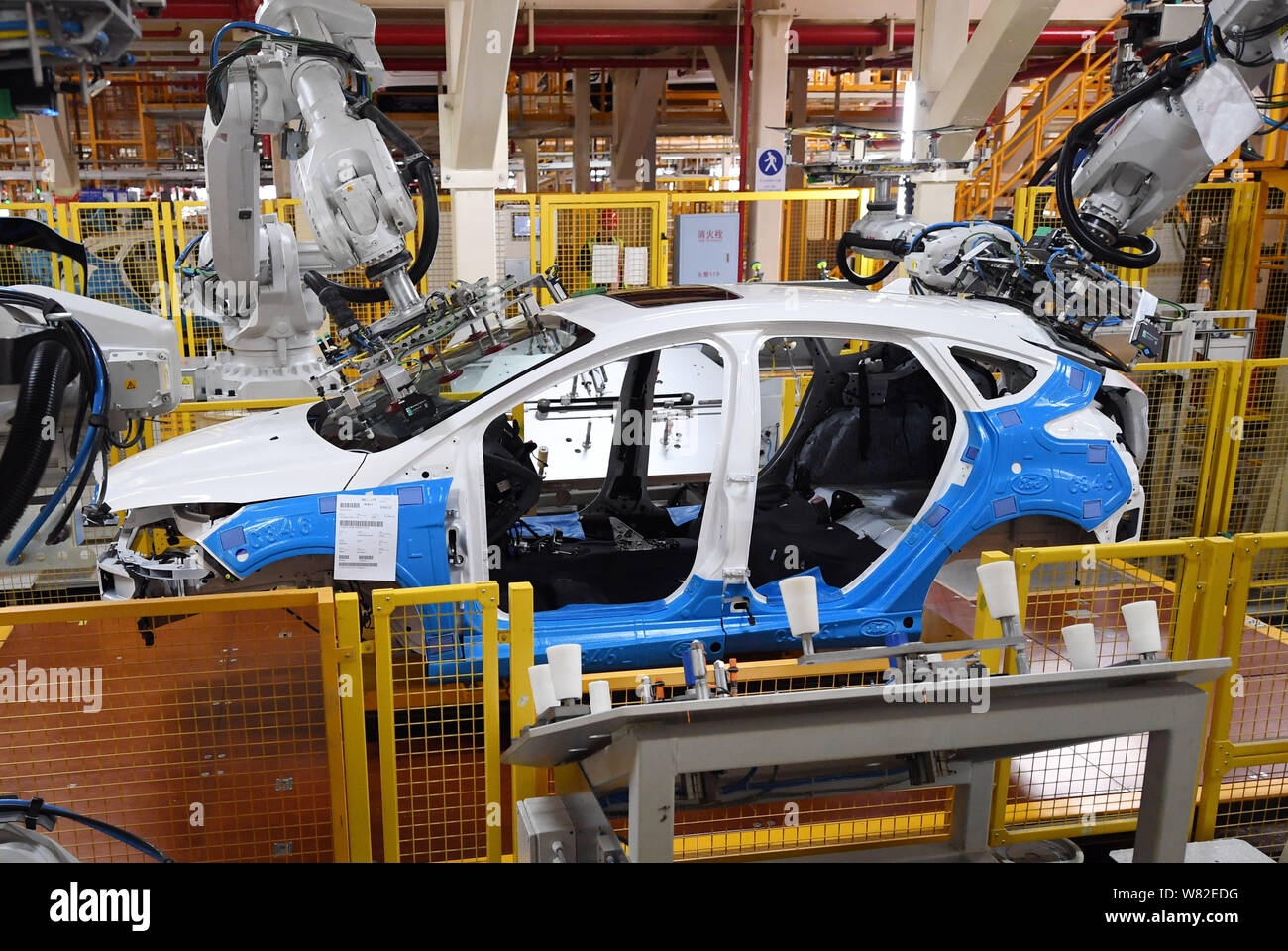 Chinese workers assemble cars on the production line at the fifth base ...