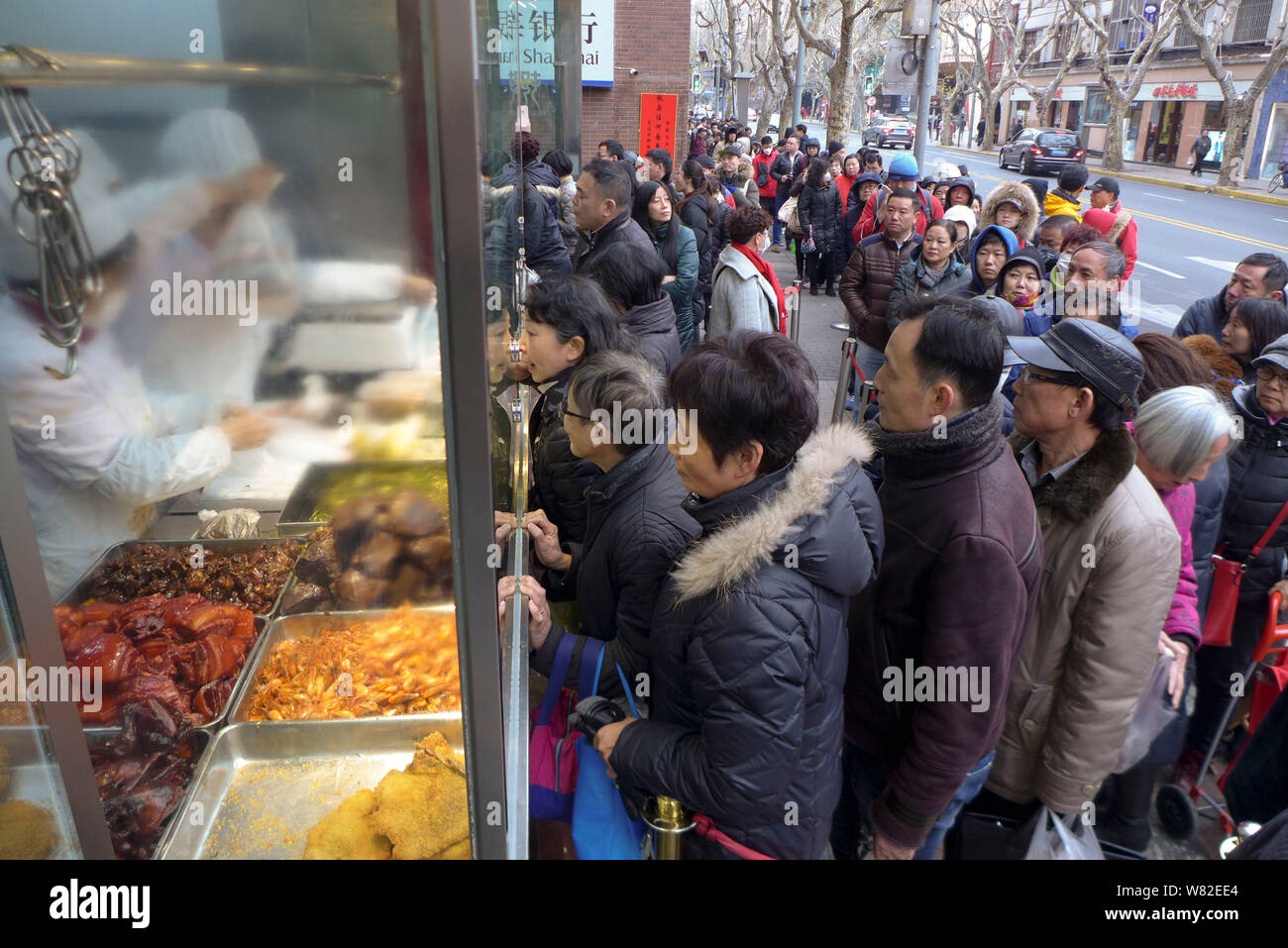 Customers queue up to buy take-out food for the Chinese Lunar New Year ...