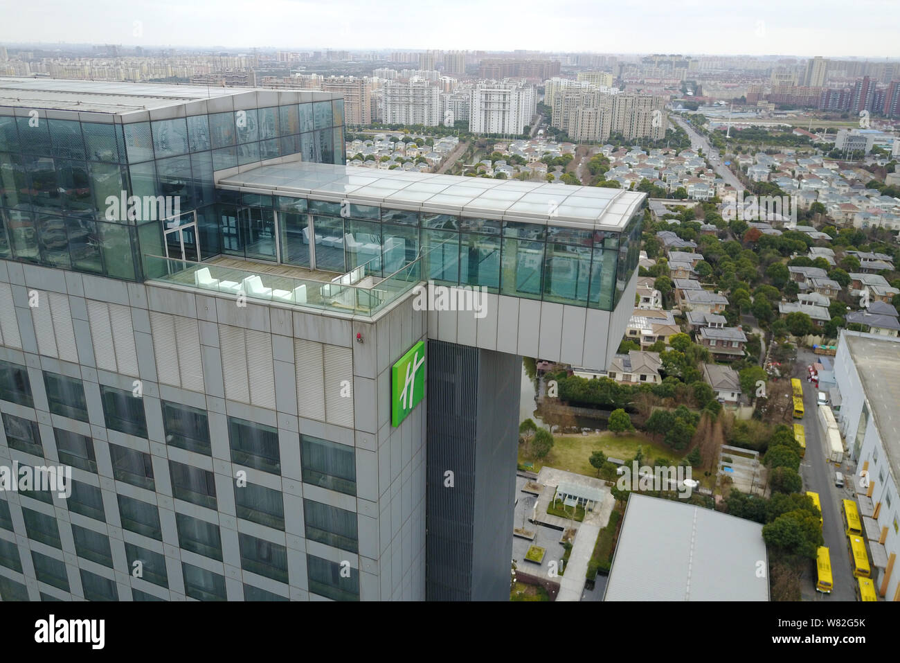 View of a swimming pool with one end suspended in the air at a high ...
