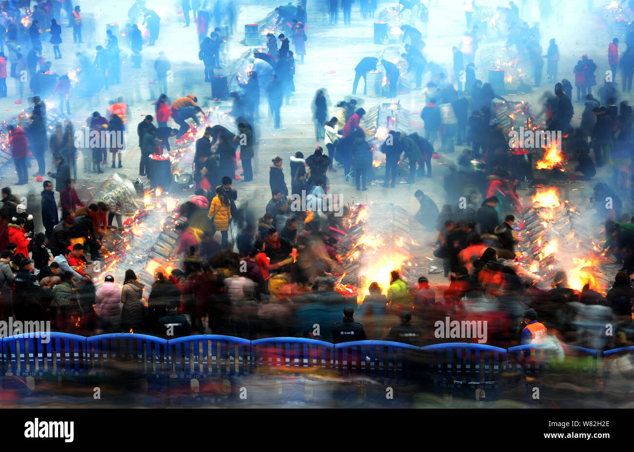 Chinese worshippers burn incense sticks to pray for wealth and ...