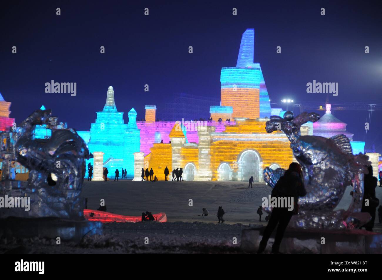 --FILE--Visitors look at illuminated ice sculptures during the 18th ...