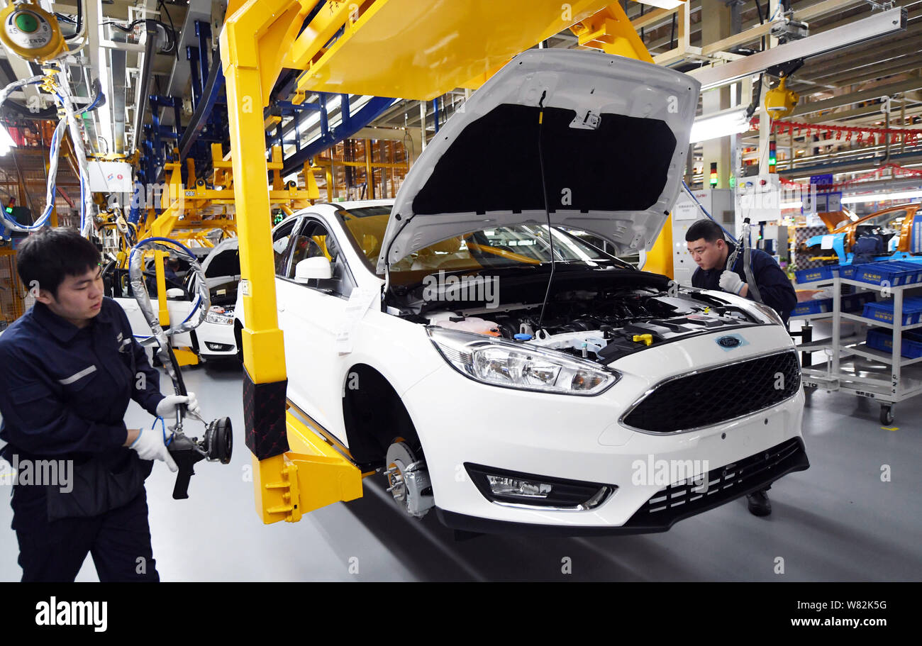 Chinese workers assemble cars on the production line at the fifth base ...