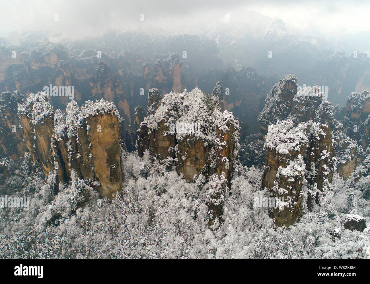 Aerial view of sea of clouds over the snow-covered mountains at ...