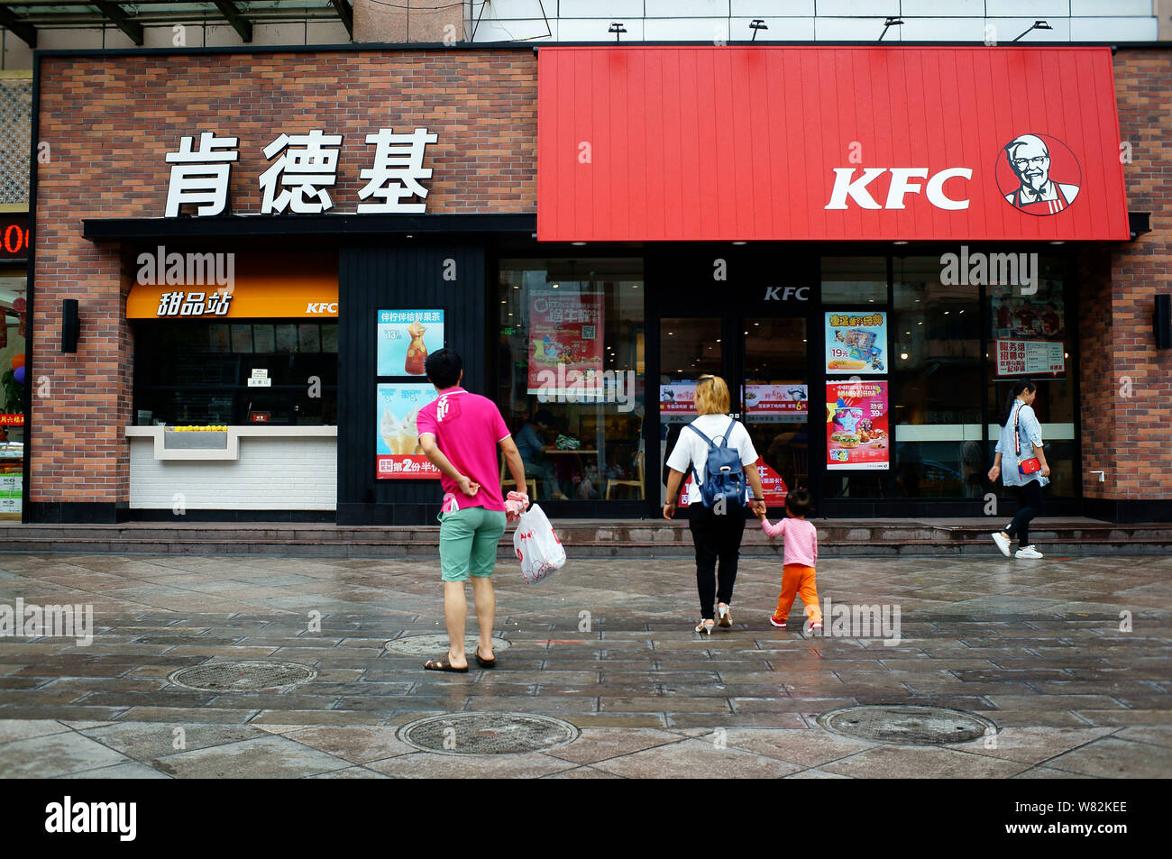 --FILE--Pedestrians walk past a fastfood restaurant of KFC of Yum ...