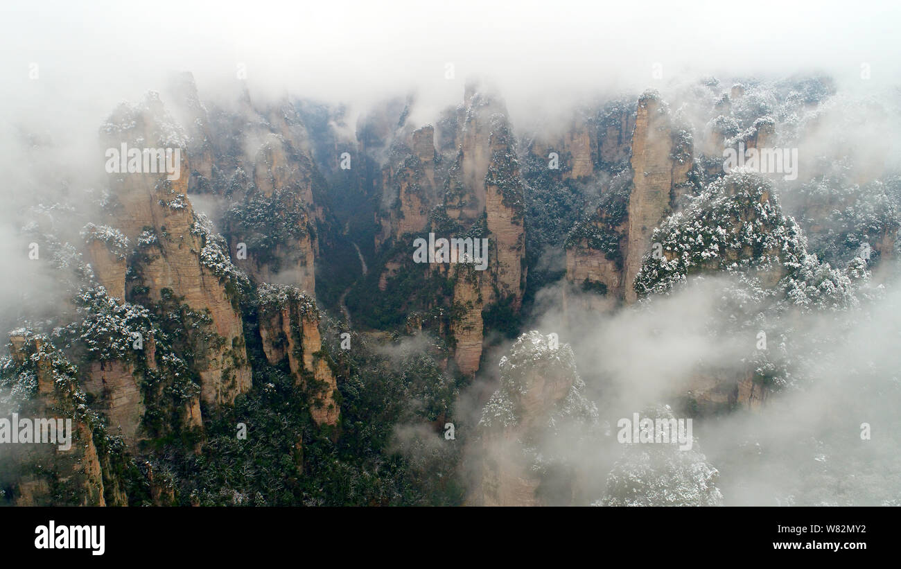 Aerial view of sea of clouds over the snow-covered mountains at ...