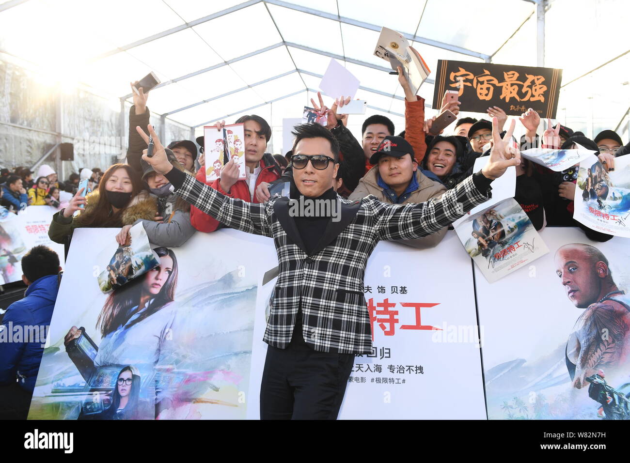 Hong Kong actor Donnie Yen poses for photos with fans as he arrives on ...