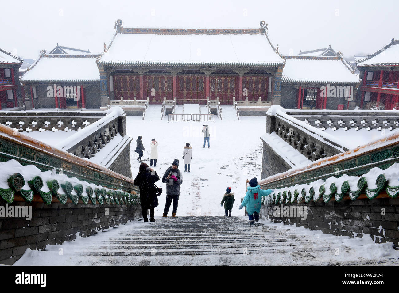 Visitors look at the Mukden Palace, also known as the Shenyang Imperial ...