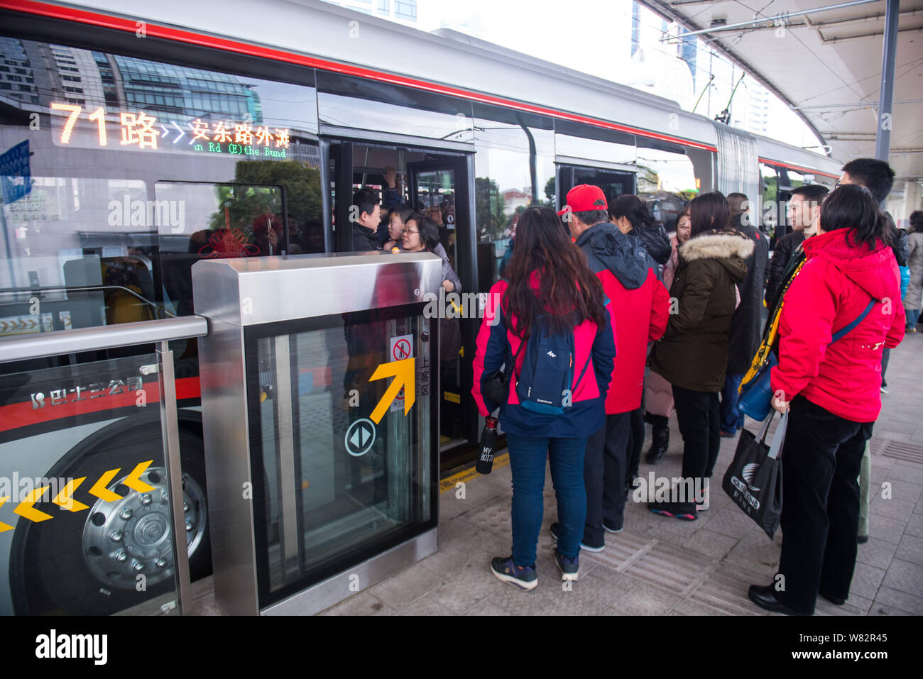 Passengers prepare to get on the congestion-defying Bus No. 71 at its ...