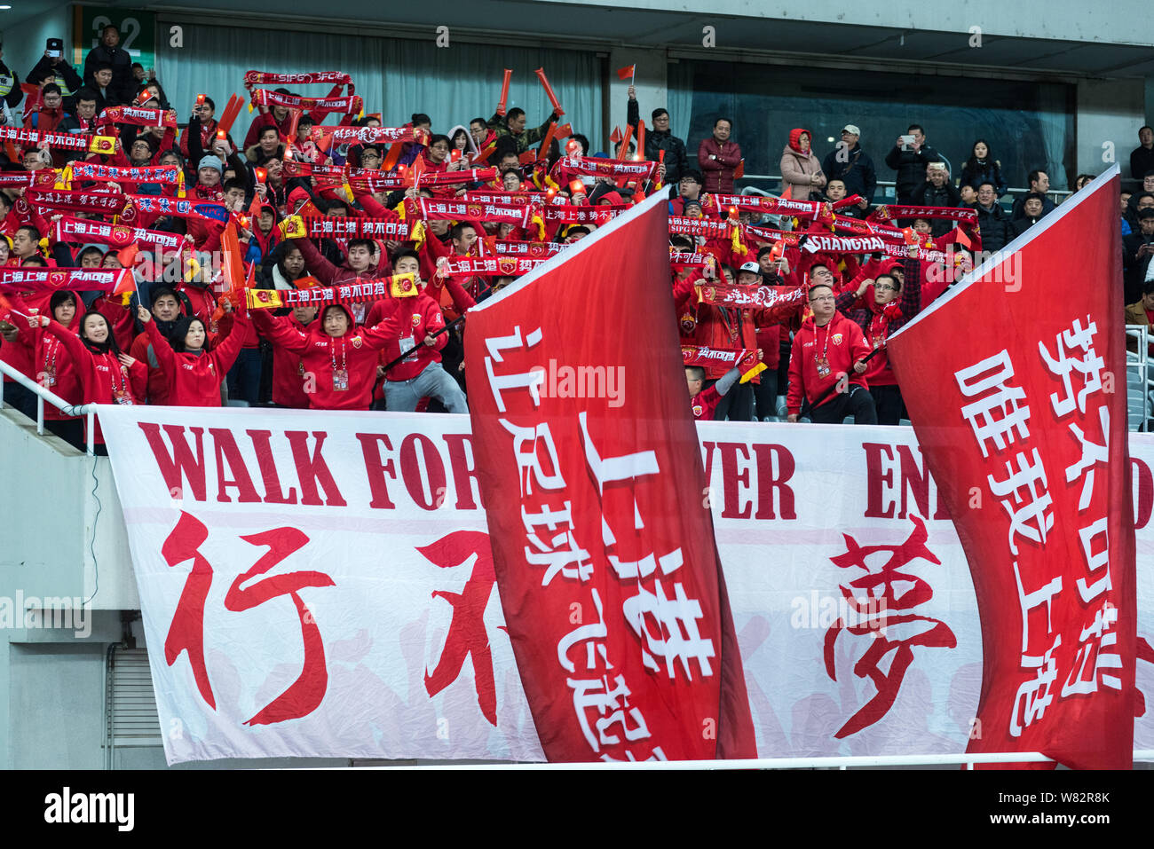 Chinese football fans wave flags and shout slogans to show support for ...