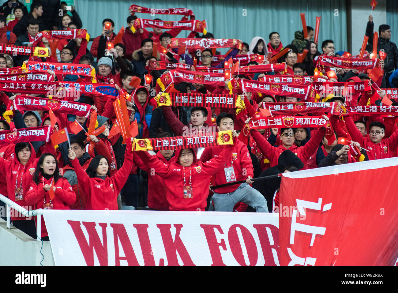 Chinese football fans shout slogans to show support for China's ...