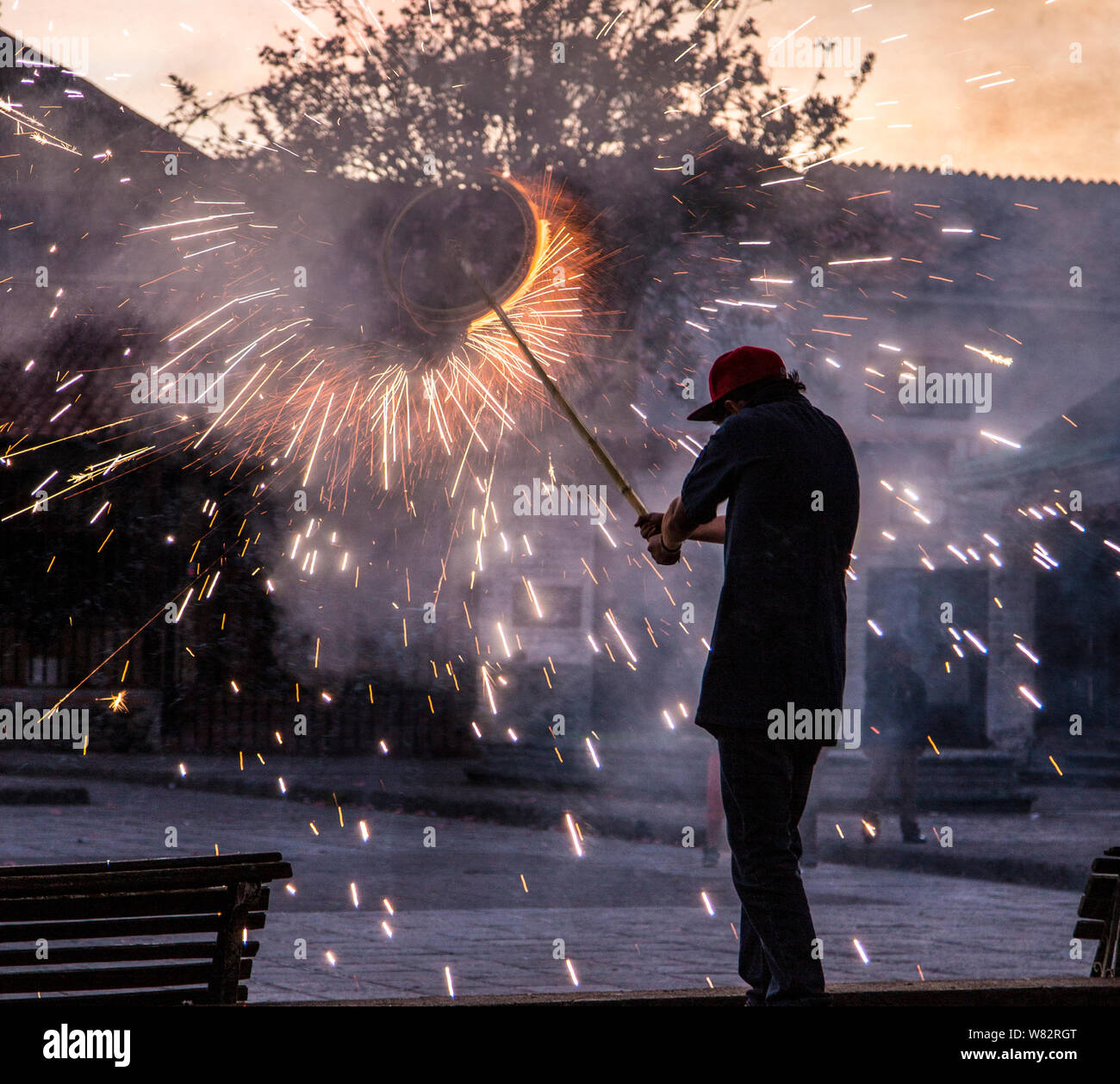 Cuenca, Ecuador - Nov 29, 2012: Man holds fireworks pinwheel at the end ...