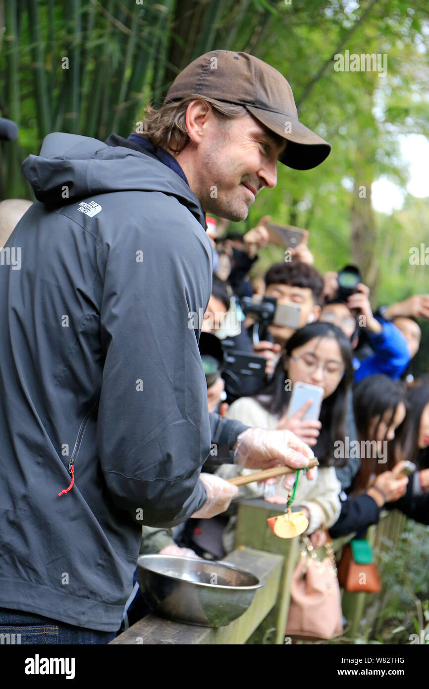 American actor Lee Pace prepares to feed a giant panda with apple at ...