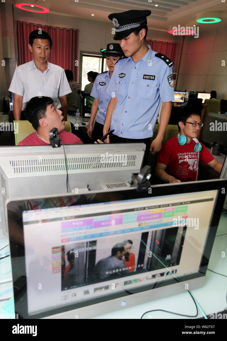 --FILE--Chinese police and law enforcement officers check ID cards of ...