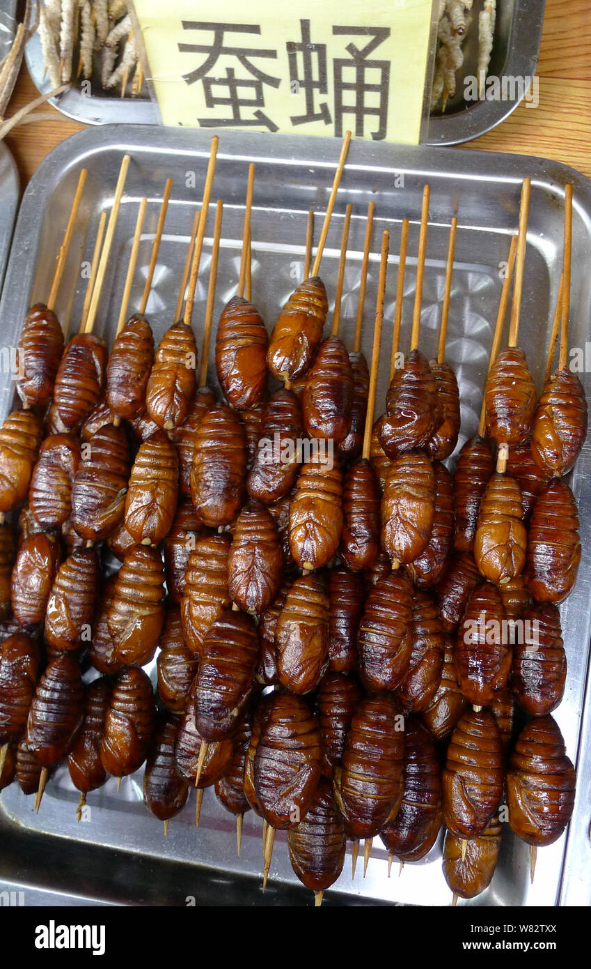 Fried cicadas are for sale at a stall in a temple fair in Qingdao city ...