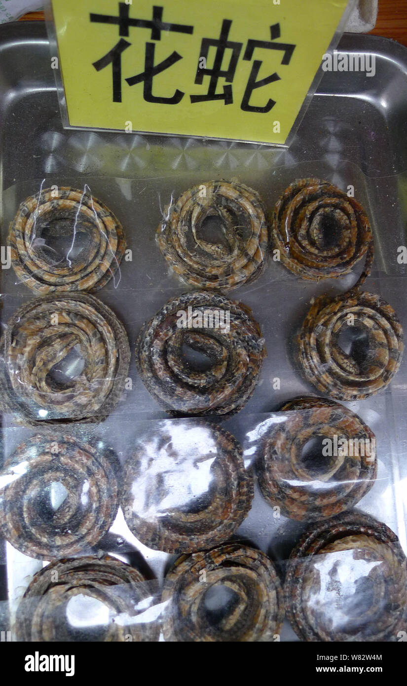 Fried snakes are for sale at a stall in a temple fair in Qingdao city ...