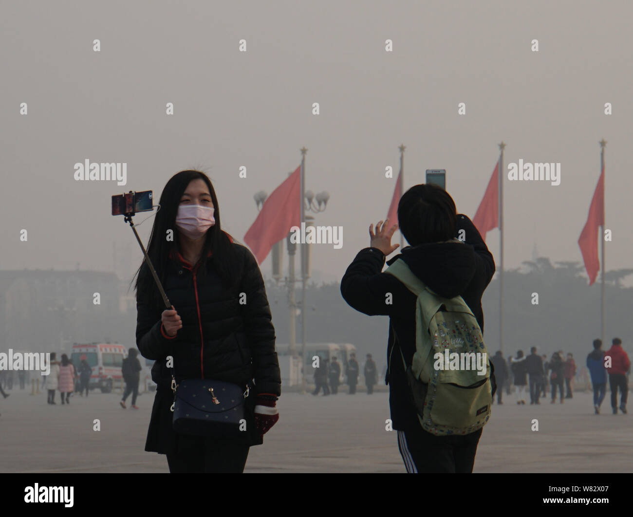 --FILE--Tourists wearing face masks against air pollution visit the ...