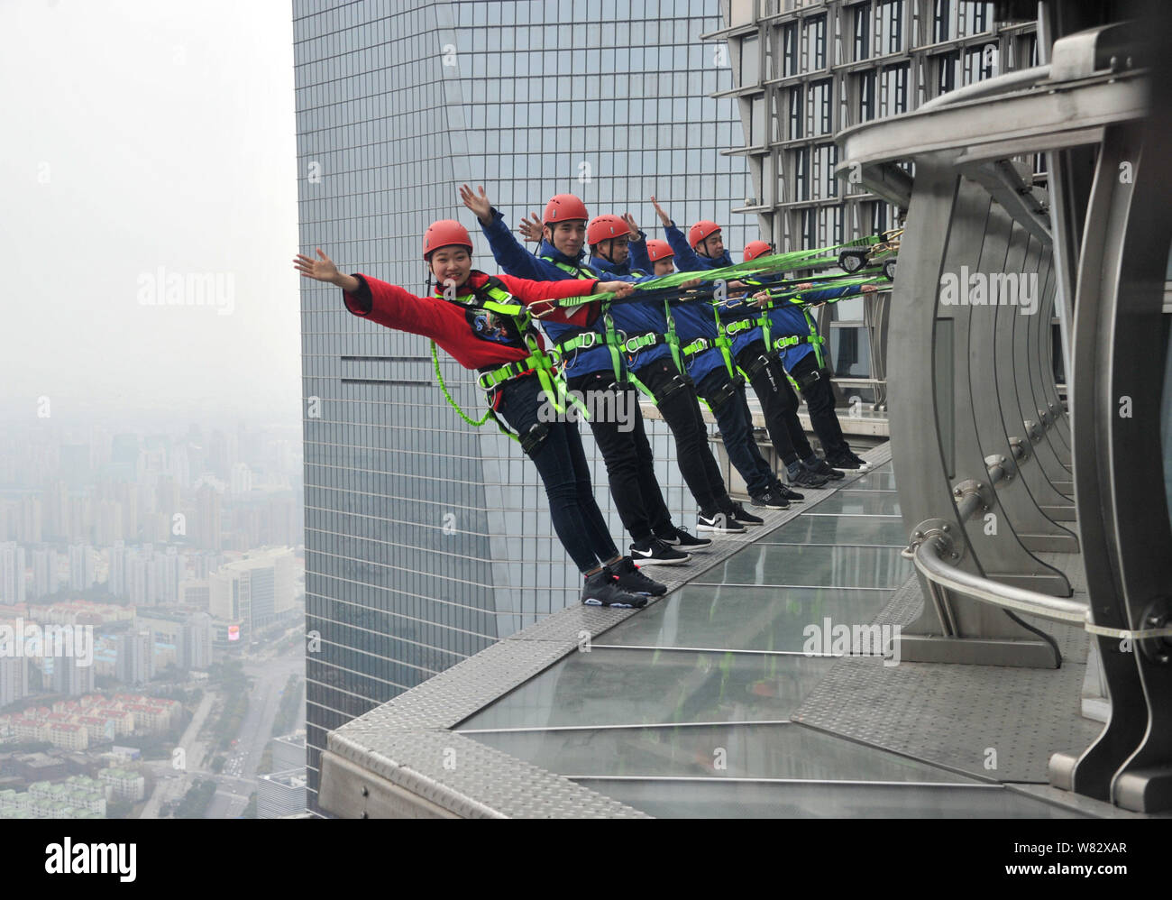 Chinese security worker Liu Jing and her colleagues equipped with ...