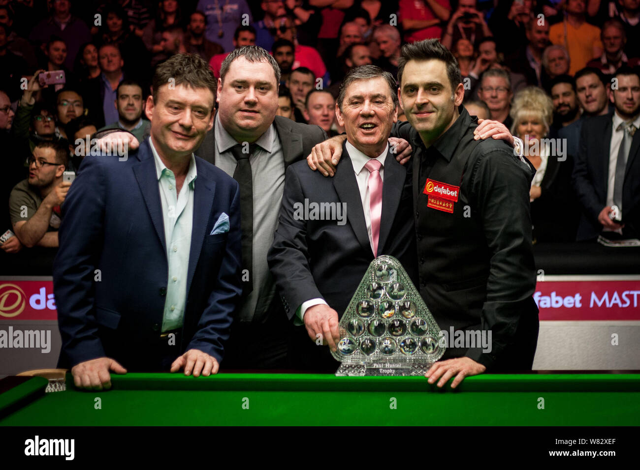 Ronnie O'Sullivan of England, right, poses with the Paul Hunter Trophy ...