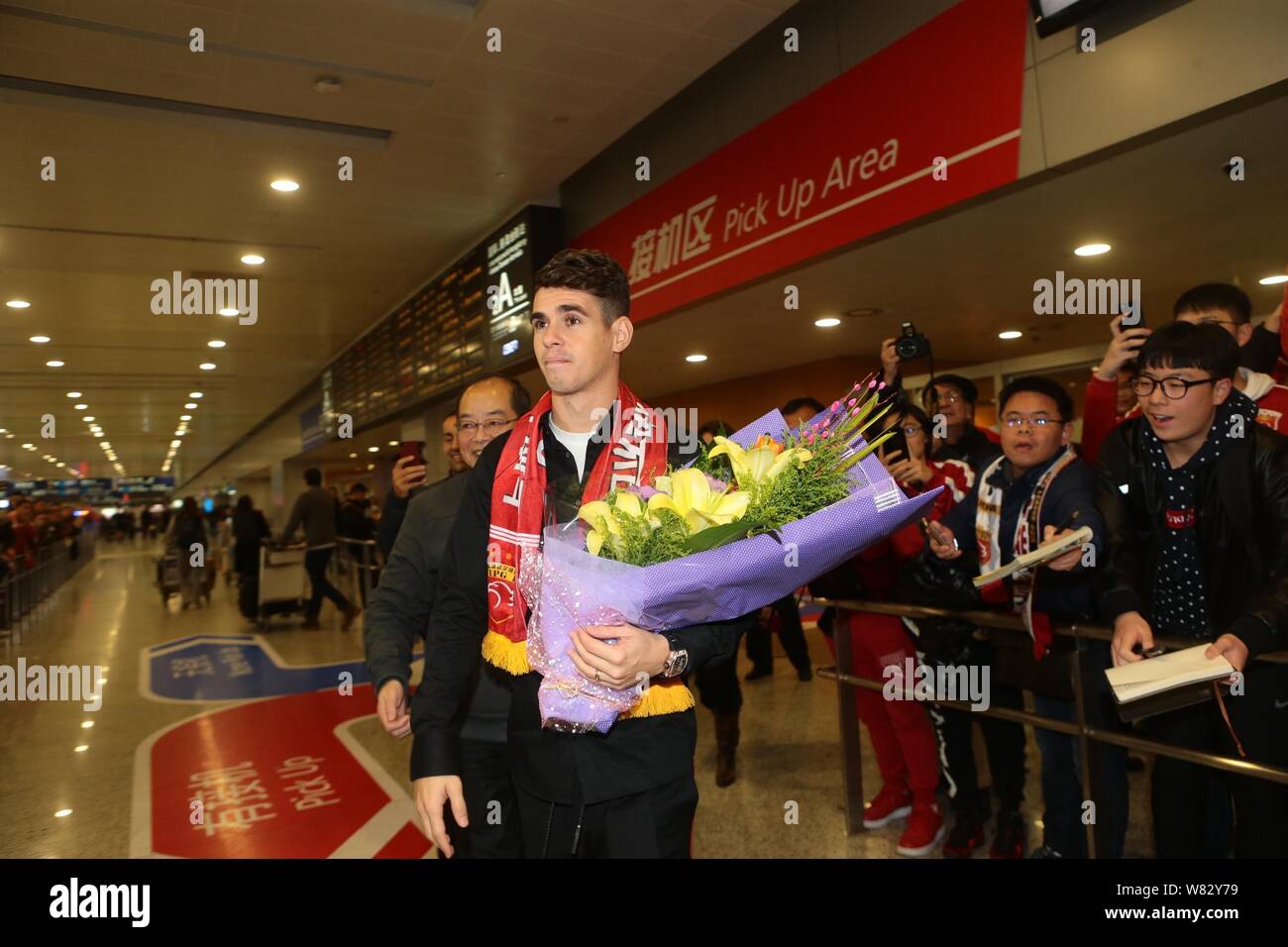 Brazilian football player Oscar is pictured after arriving at the Shanghai Pudong International ...