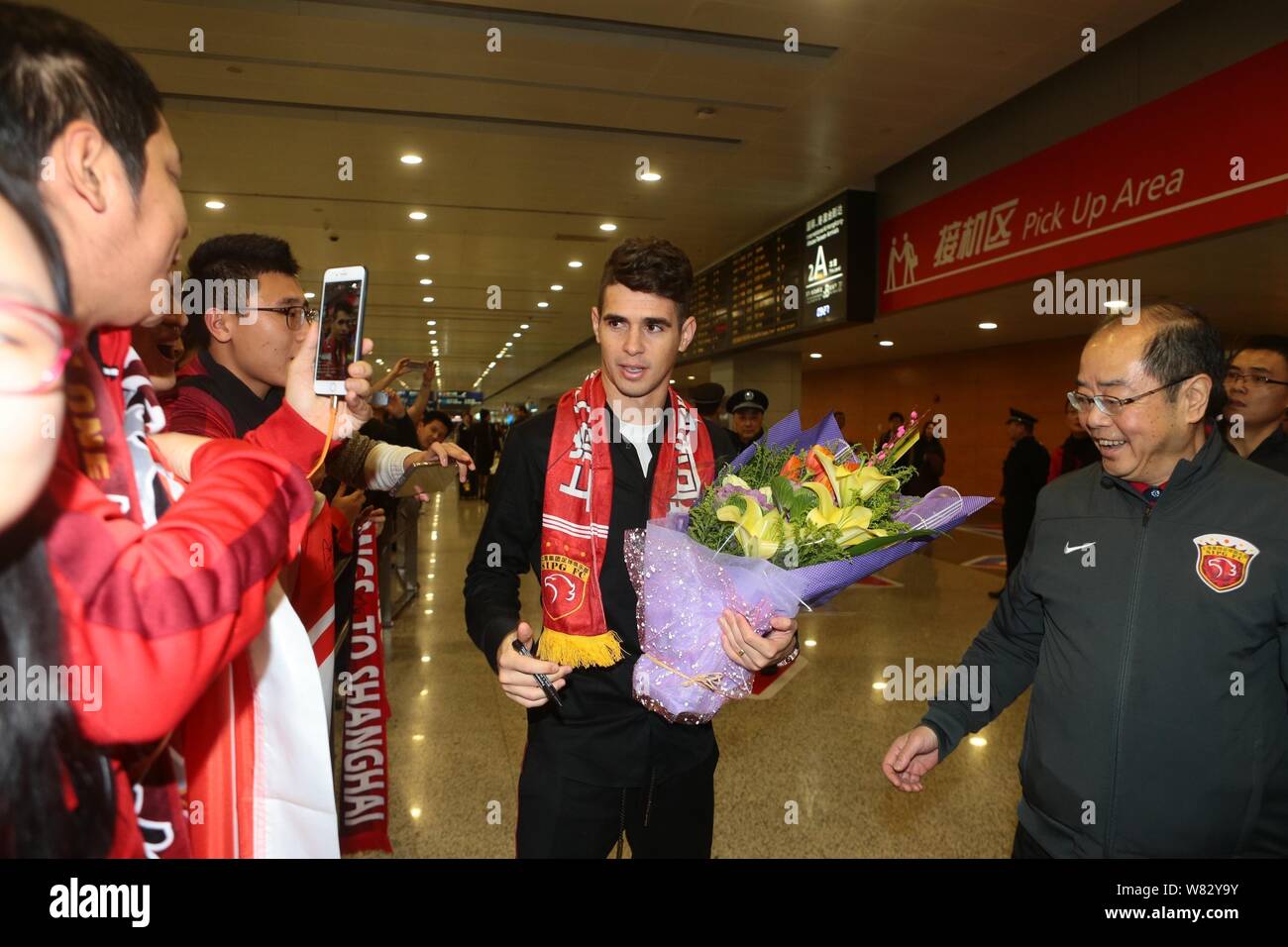 Brazilian football player Oscar, center, is pictured after arriving at ...