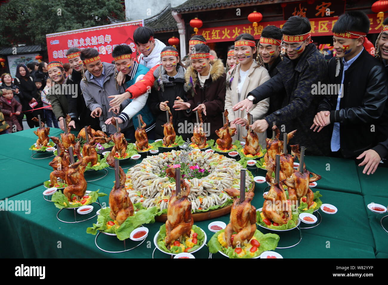 Chinese participants take part in a chicken-eating competition to ...