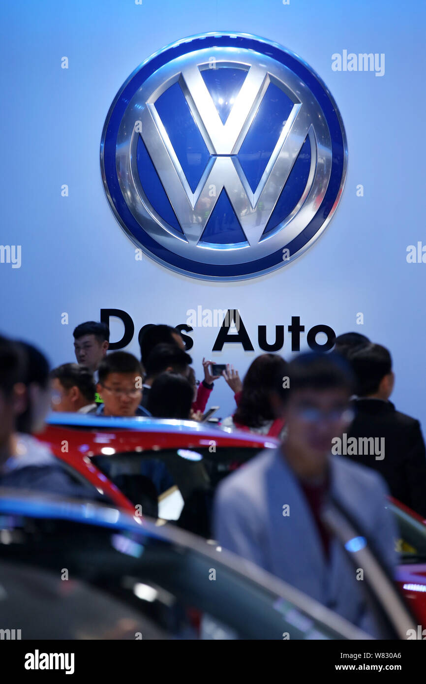--FILE--Visitors look at Volkswagen (VW) cars on display during the ...
