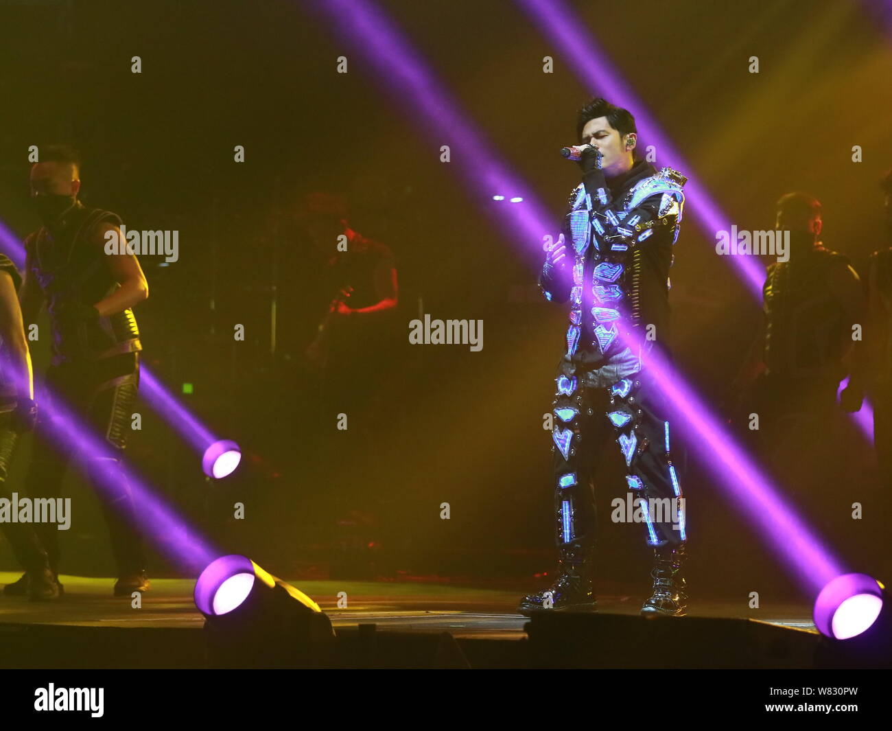 Taiwanese singer Jay Chou performs at a concert with colorful lights ...