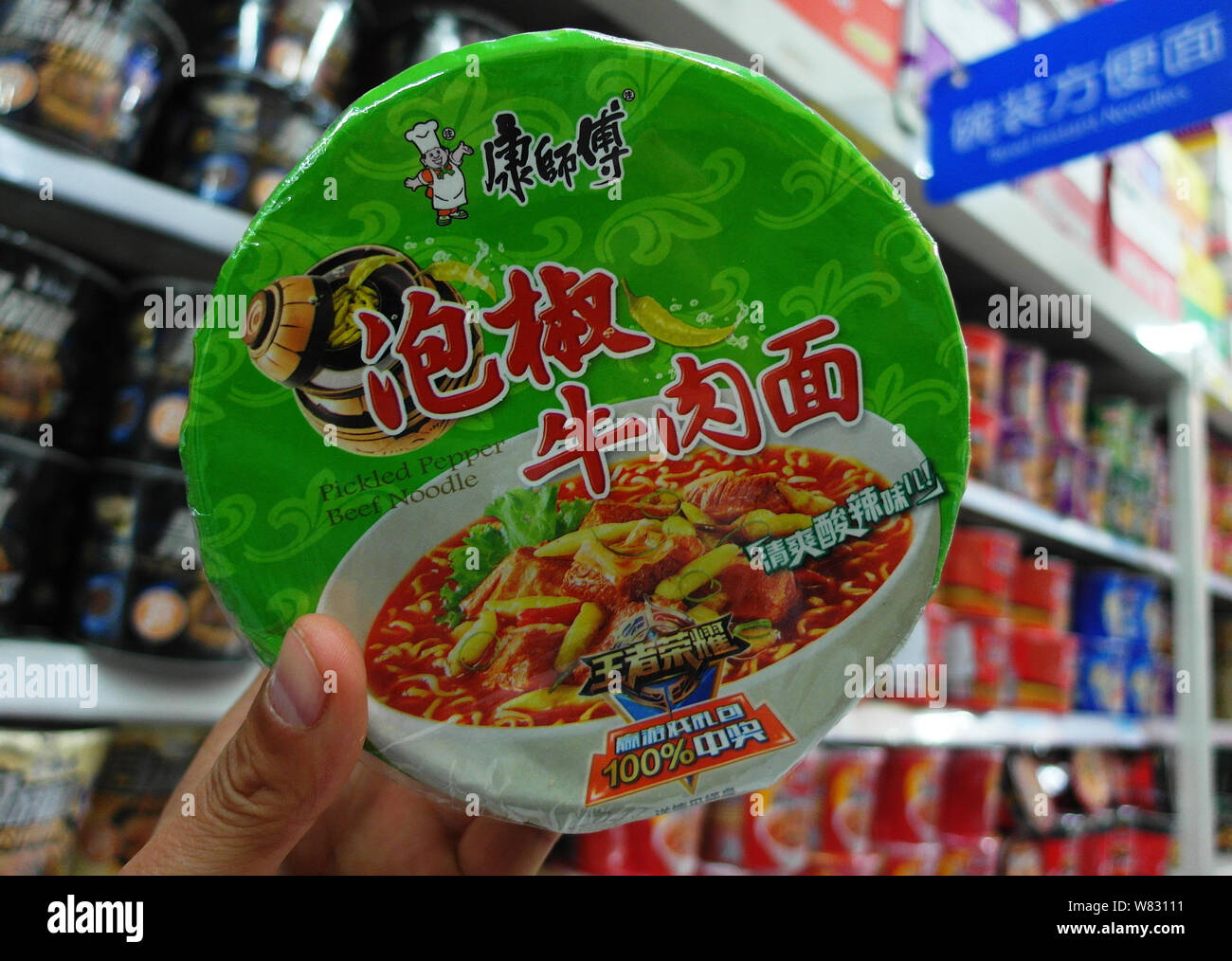 A Chinese customer shops for Master Kong instant noodle of Tingyi ...