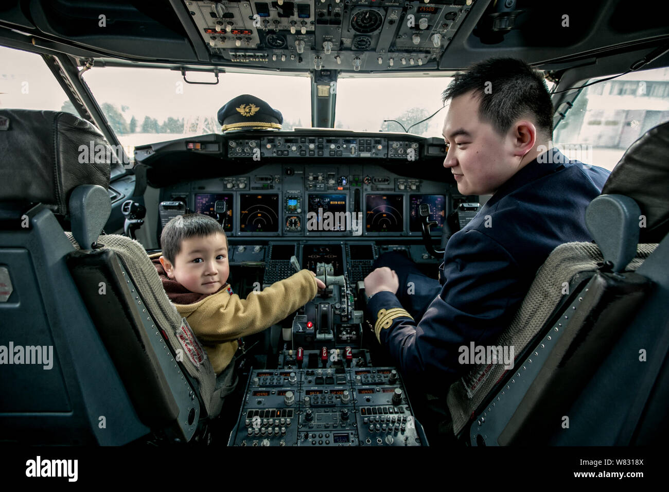 The four-year-old legless boy Li Haifeng, left, poses with a pilot of ...