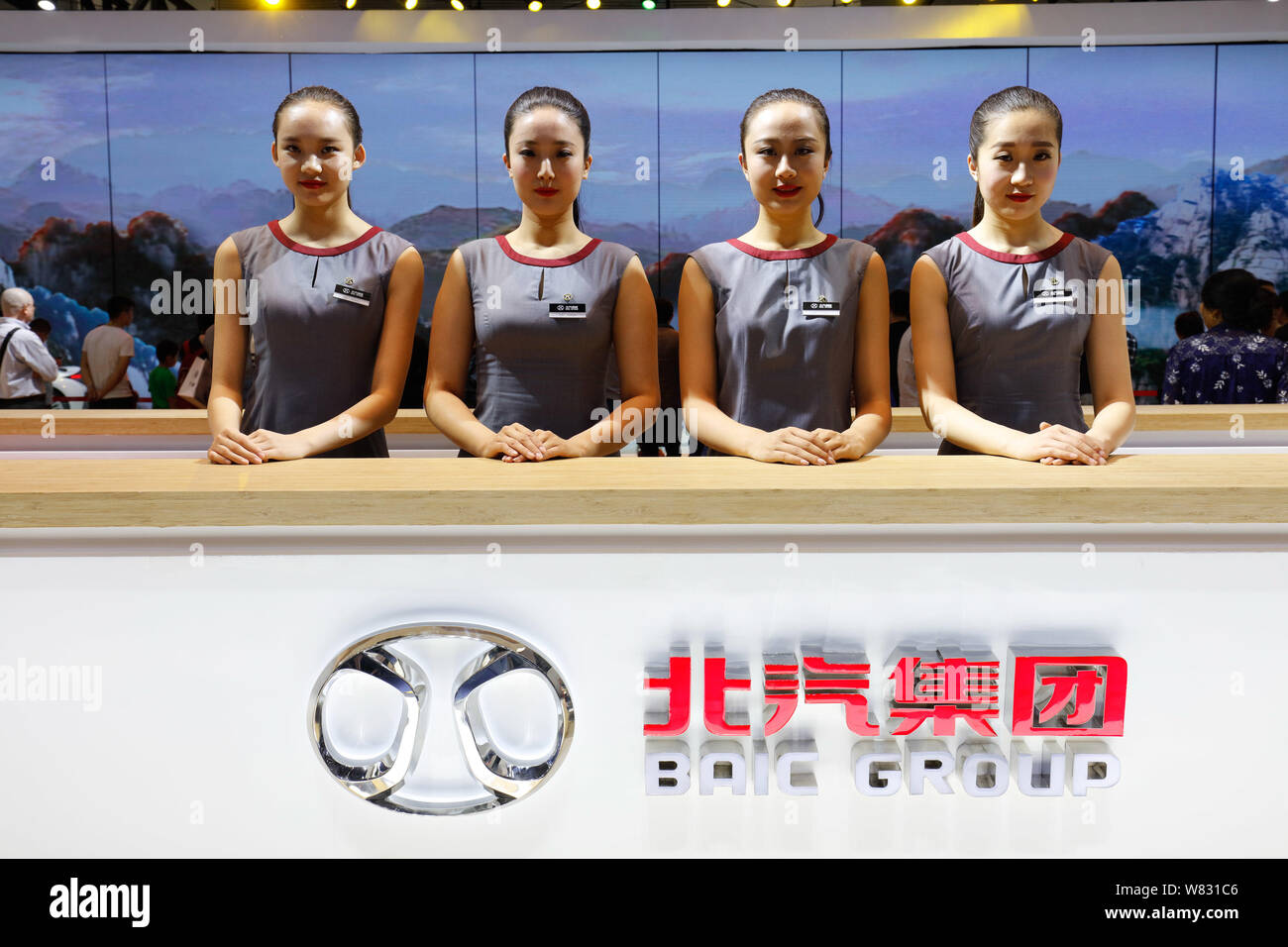 --FILE--Chinese employees are seen at the stand of BAIC Group during ...