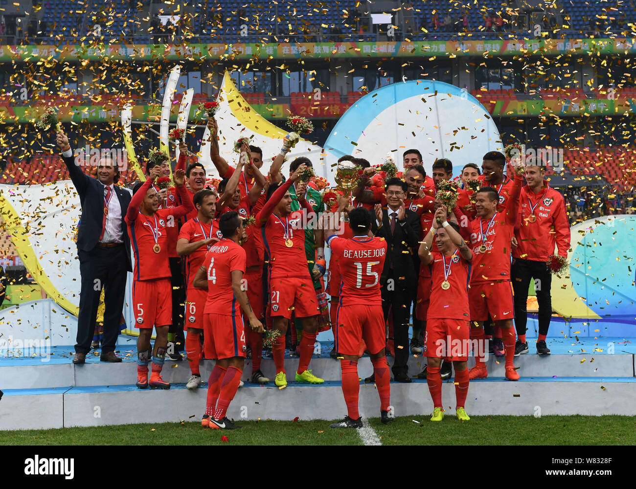 Players of Chile pose for photos with their trophy after defeating ...