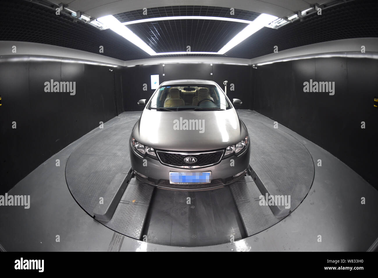 A platform carrying a car is to be lowered at a parking spot in Nanjing ...