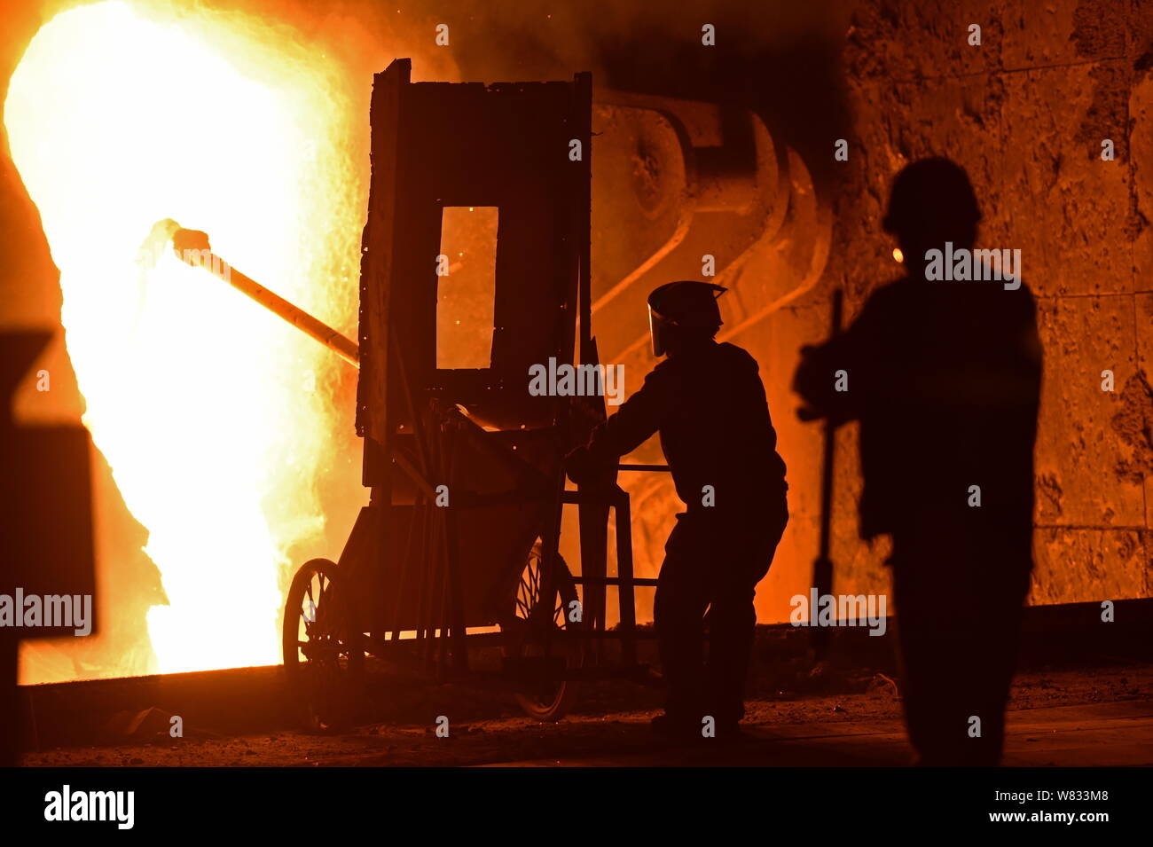 --FILE--Chinese workers produce steel at a steel plant in Taiyuan city ...