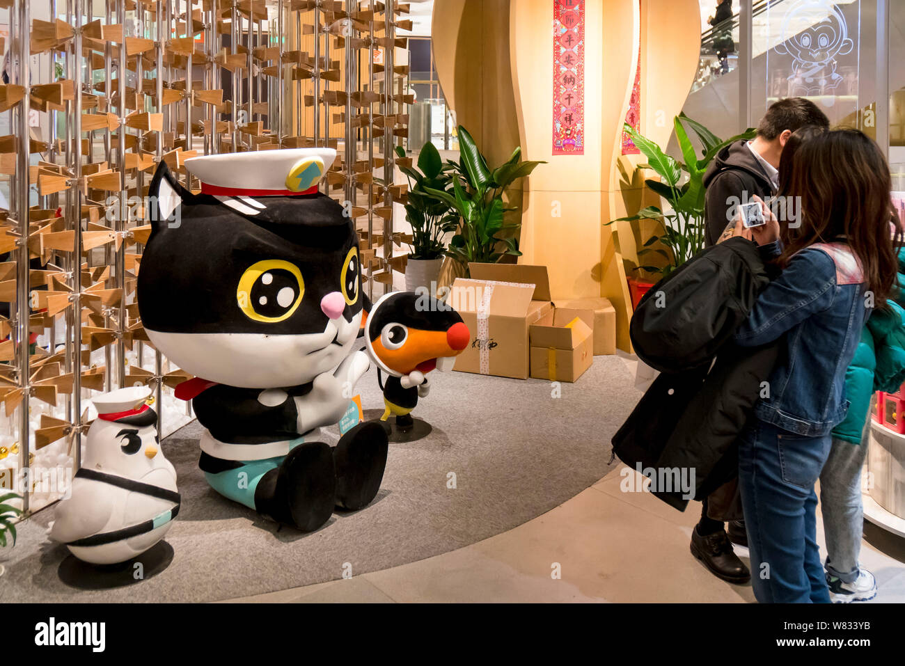 Visitors look at sculptures from Chinese cartoon "Black Cat Detective ...