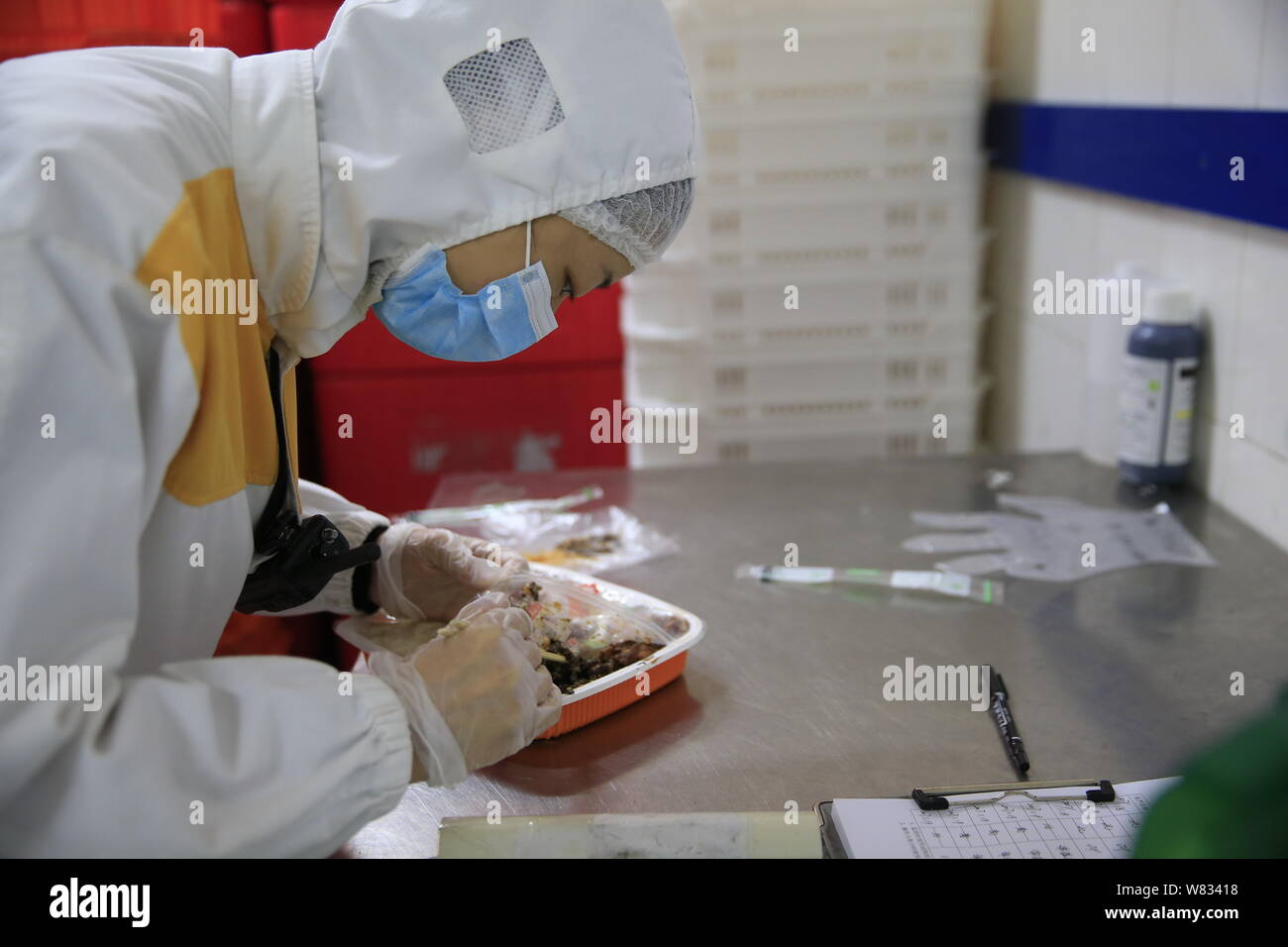A Chinese worker checks a food-filled lunch box of high-speed train ...