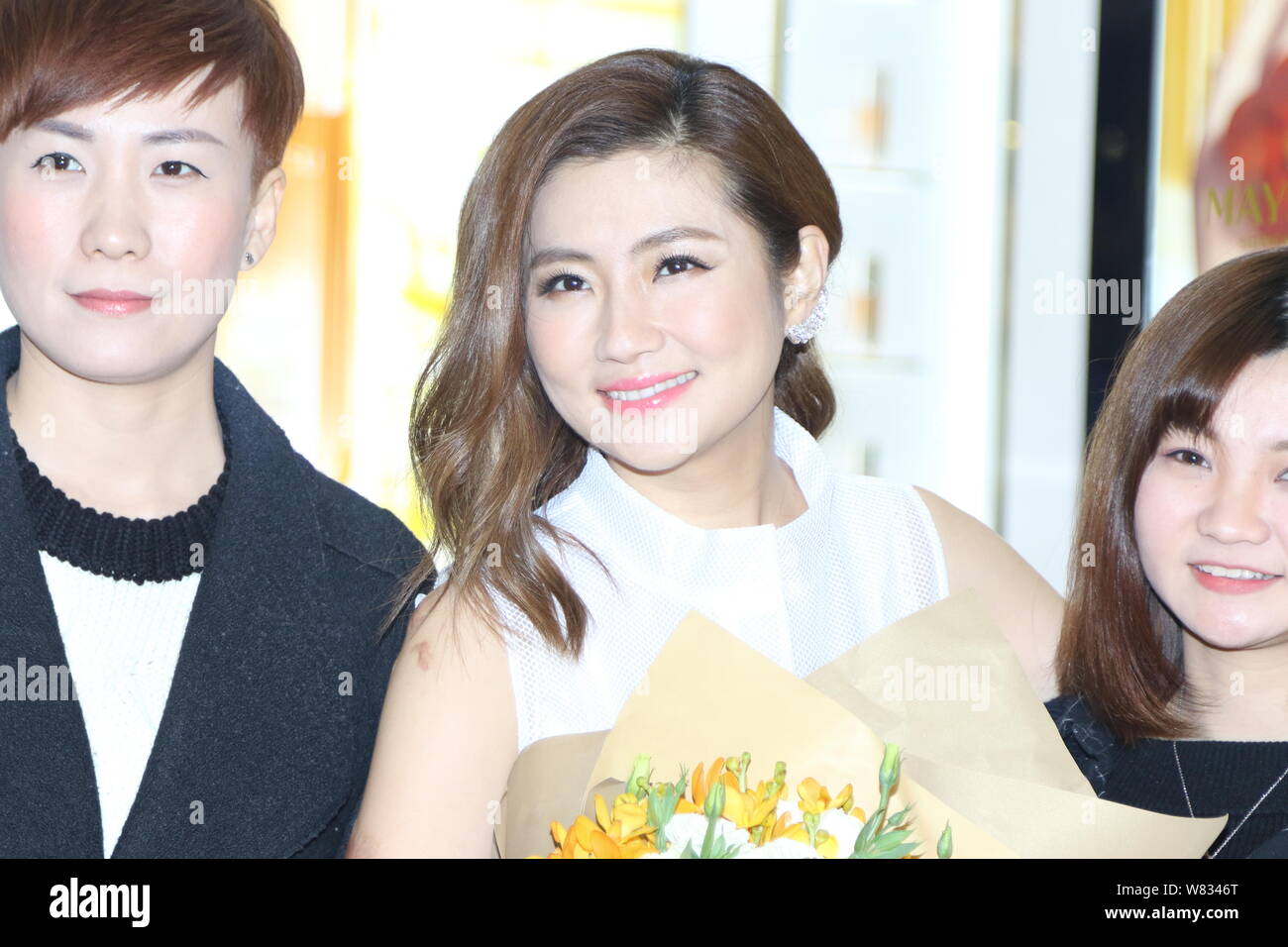 Selina Jen Chia-hsuan, center, of Taiwanese girl group S.H.E attends a promotional event of ...