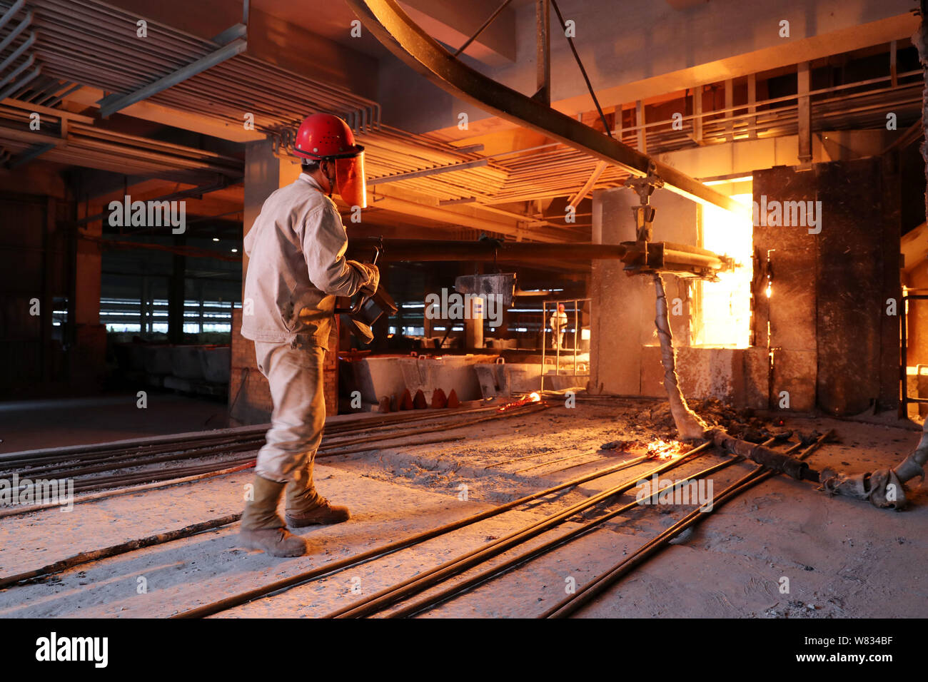 --FILE--A Chinese worker produces steel at a steel plant in Hefei city ...