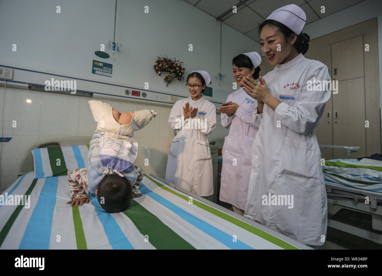 The four-year-old legless boy Li Haifeng, front left, stands upside ...