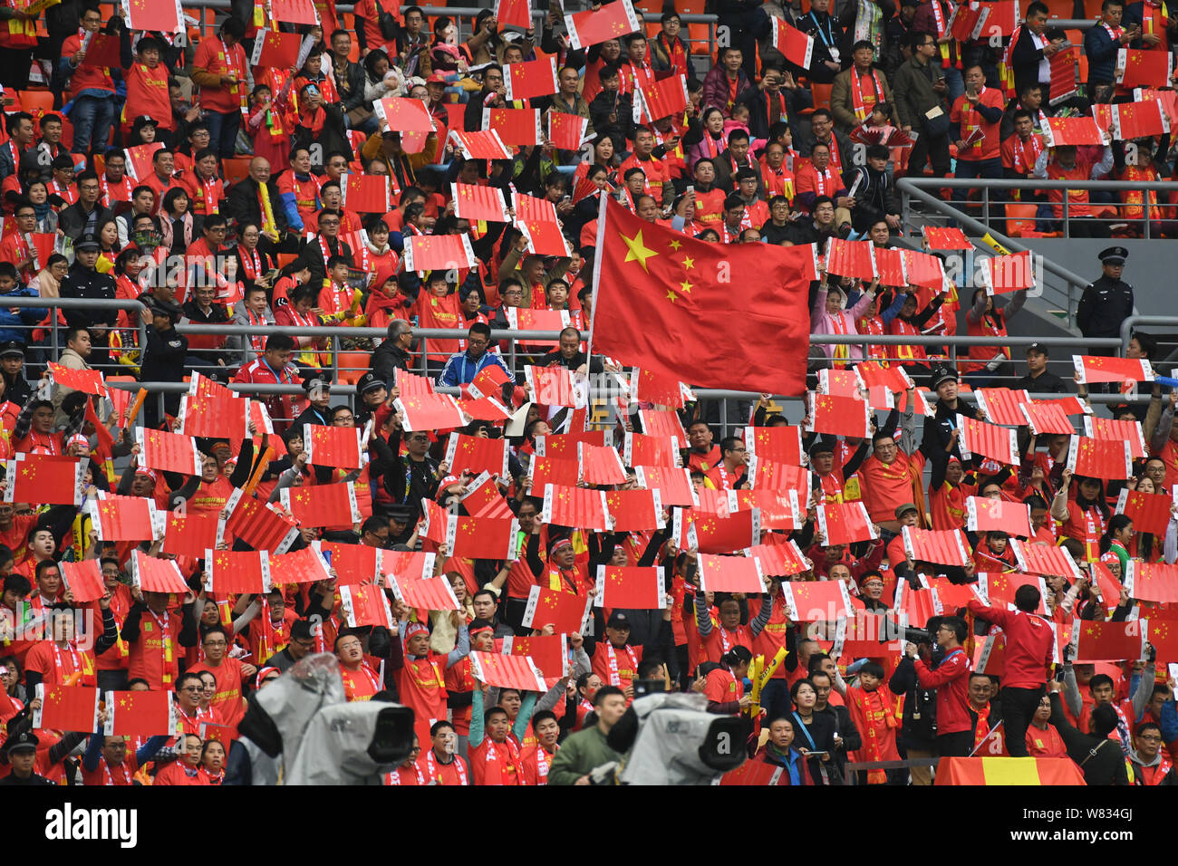 Chinese football fans wave Chinese national flags to show support for ...
