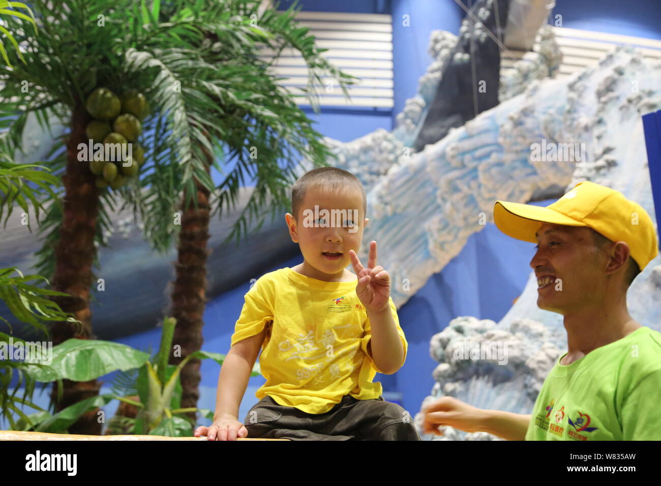 The four-year-old legless boy Li Haifeng attends a summer camp in ...