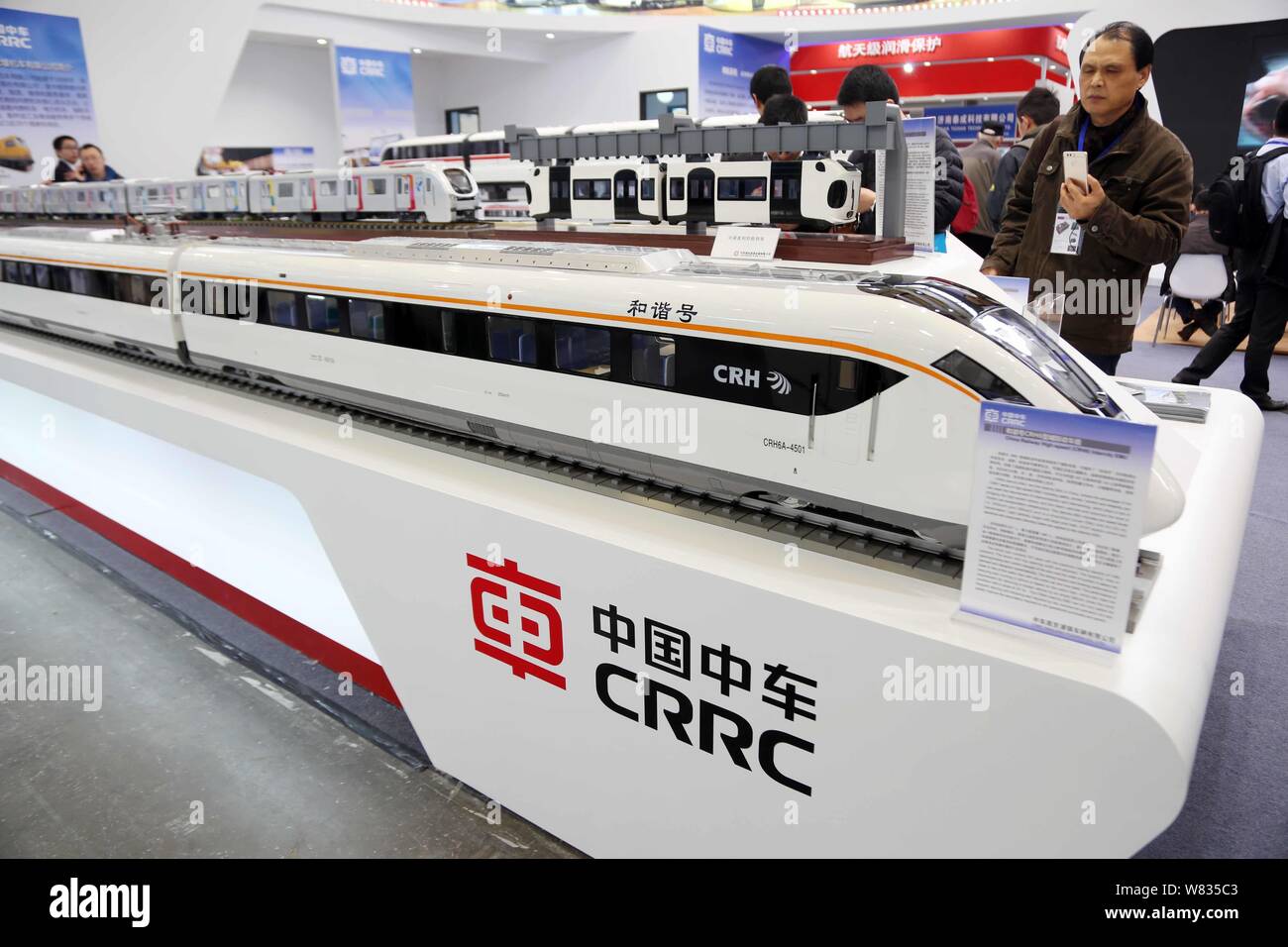 --FILE--Visitors take photos of model trains on display at the stand of ...